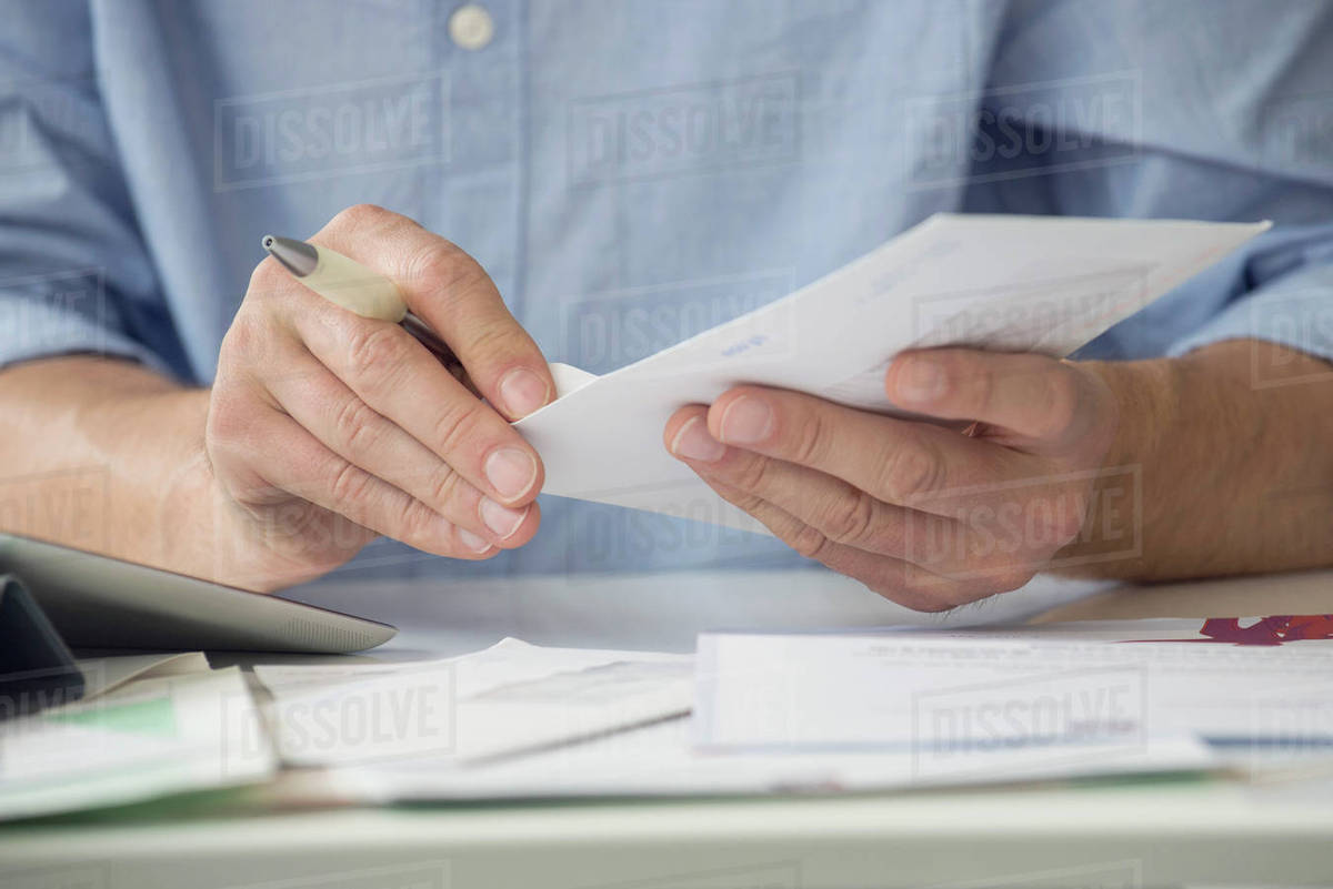 Man opening mail - Stock Photo - Dissolve
