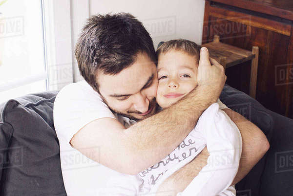 Father hugging child, portrait - Stock Photo - Dissolve