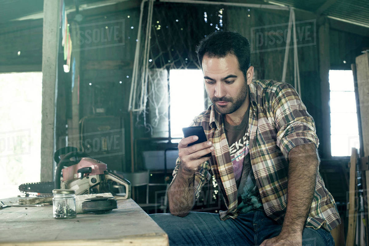 Man browsing internet with smartphone during work break - Royalty-free ...