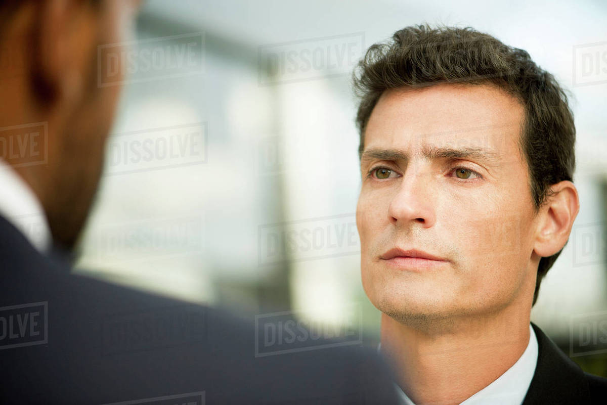Businessman having serious conversation with colleague - Royalty-free ...