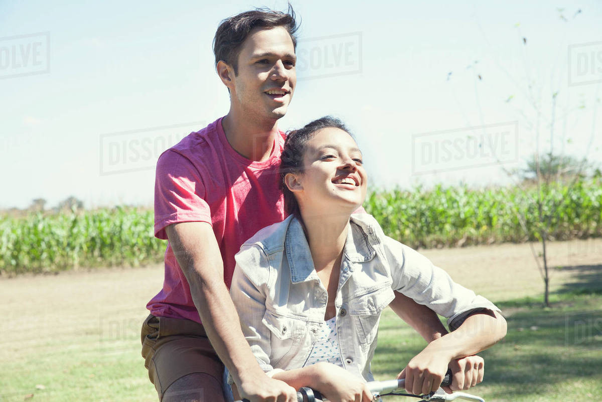 Couple riding bike together - Royalty-free Stock Photo | Dissolve