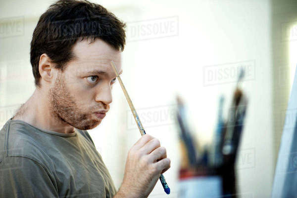 Artist working on oil painting in art studio - Royalty-free Stock Photo ...