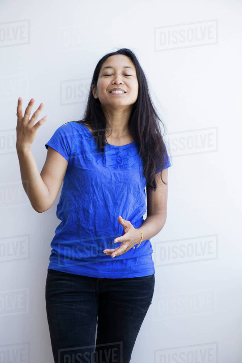 Woman making expressive gestures with hands while talking - Royalty ...