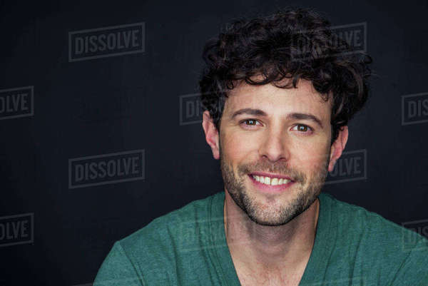 Man smiling cheerfully, portrait - Stock Photo - Dissolve