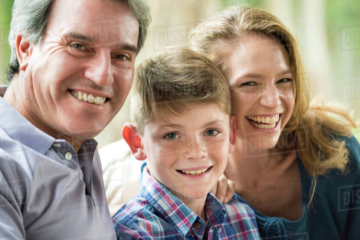 Family smiling together, portrait - Royalty-free Stock Photo | Dissolve