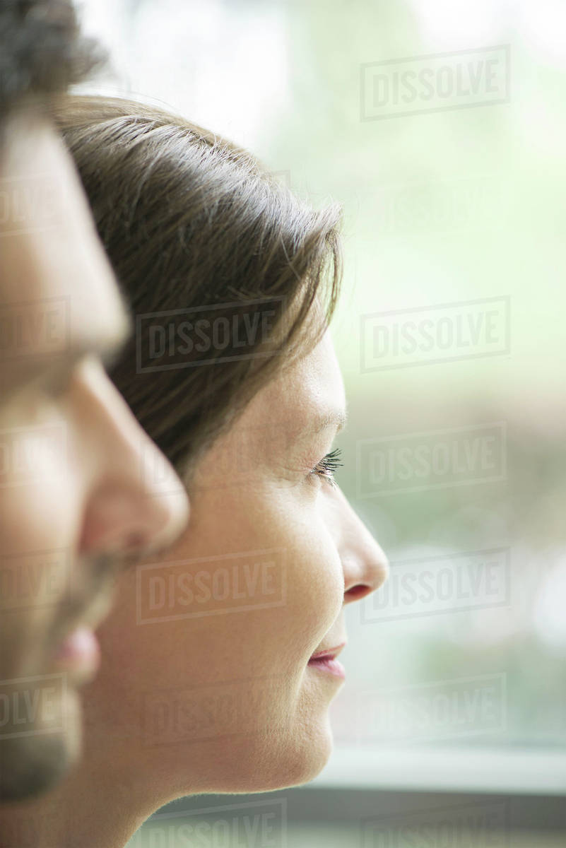 Woman gazing out window, profile - Royalty-free Stock Photo | Dissolve