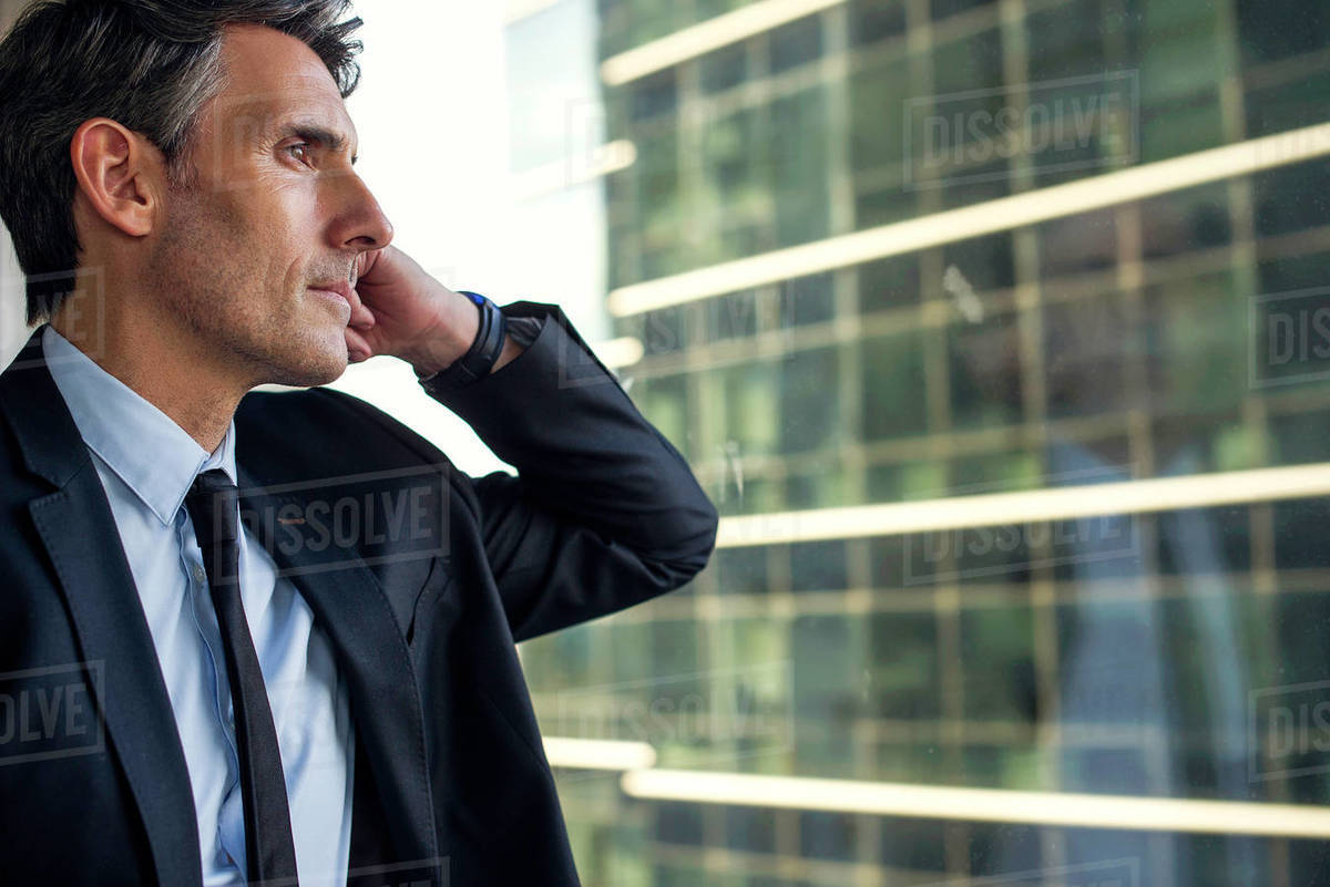 Man looking through window in high rise building - Royalty-free Stock ...