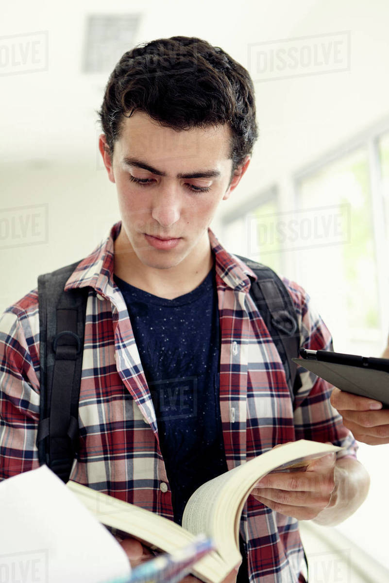 College student reading textbook - Royalty-free Stock Photo | Dissolve