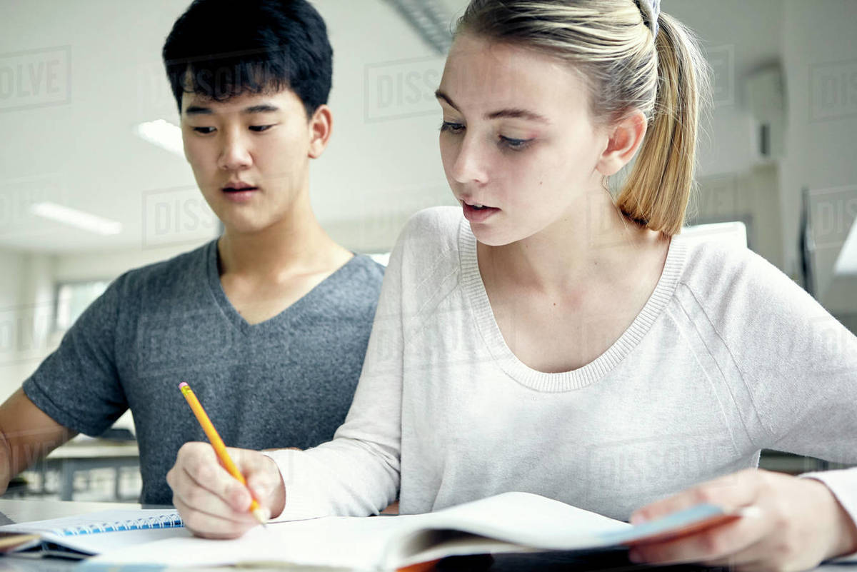 Students working on assignment at school - Royalty-free Stock Photo ...