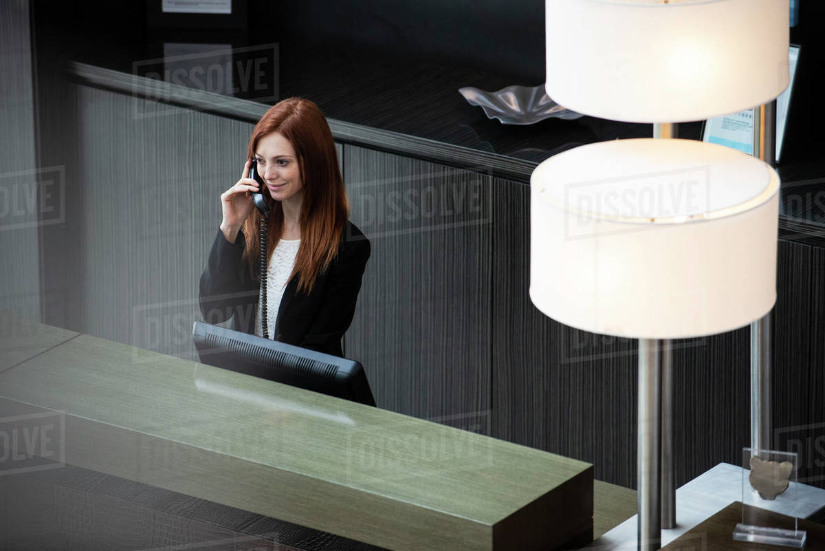 Female receptionist talking on telephone - Royalty-free Stock Photo ...