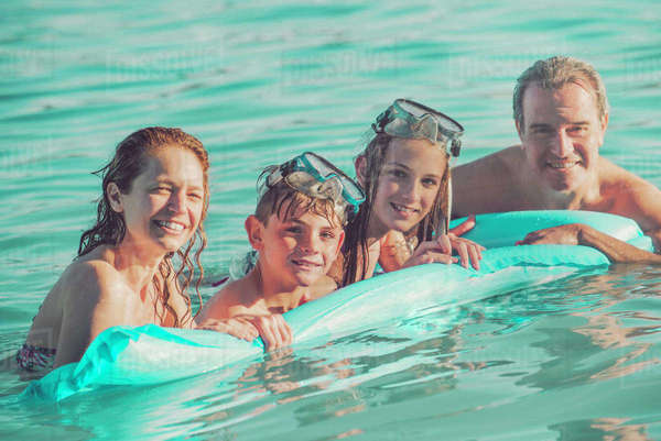Family enjoying in swimming pool - Royalty-free Stock Photo | Dissolve