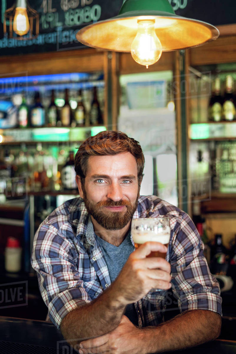 Portrait of man holding beer glass - Royalty-free Stock Photo | Dissolve