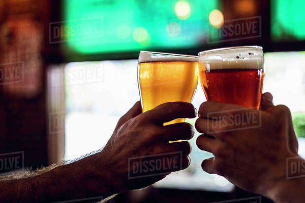 Hands toasting beer glasses - Royalty-free Stock Photo | Dissolve