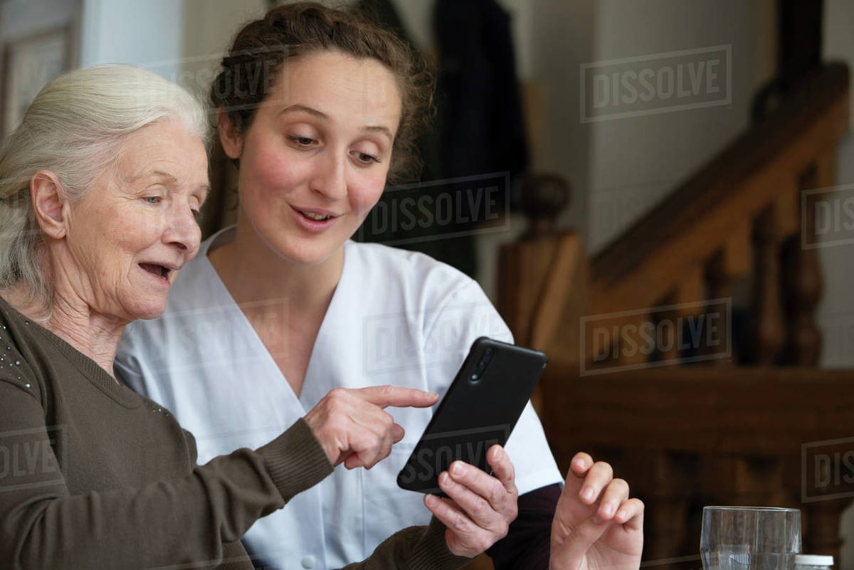 Senior patient using smartphone - Royalty-free Stock Photo | Dissolve