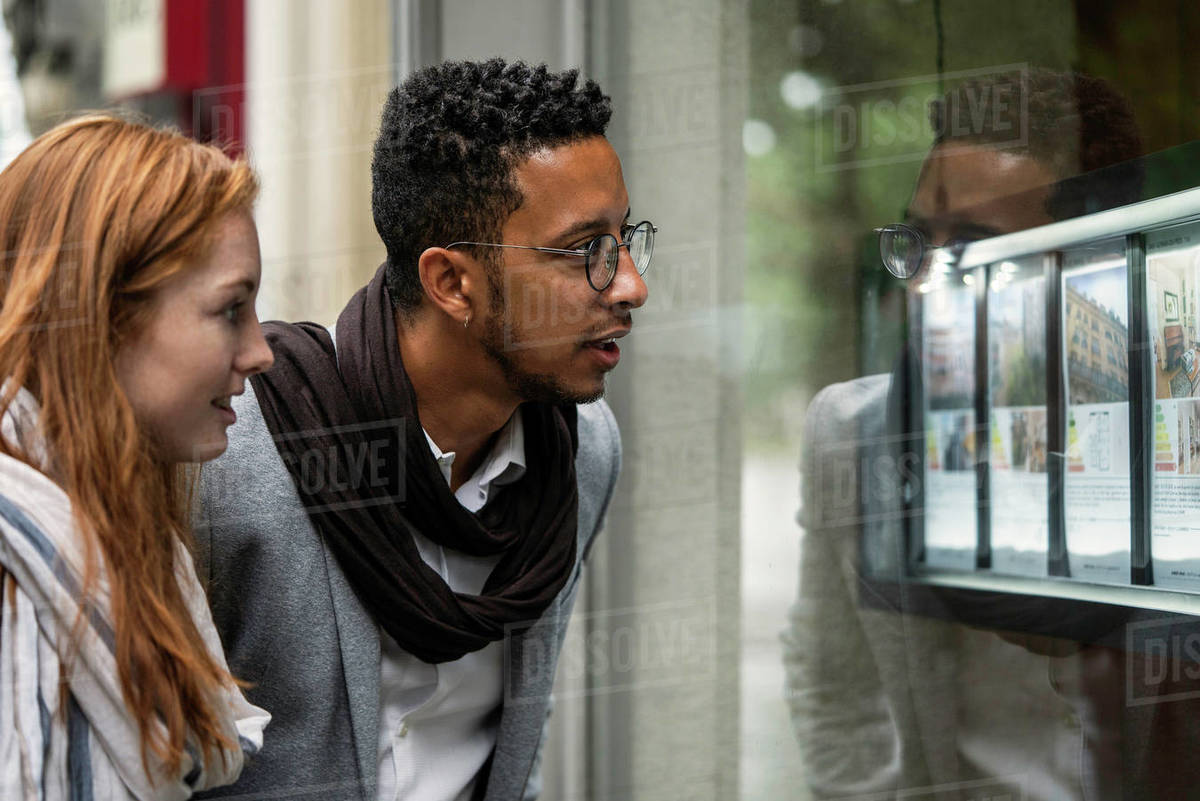 Couple looking at window display - Stock Photo - Dissolve