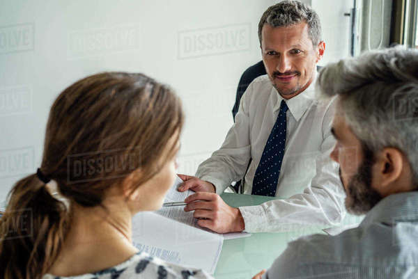 Real estate agent discussing document with couple - Royalty-free Stock ...