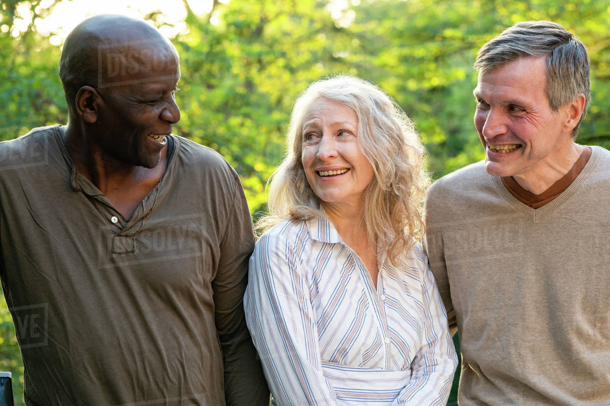 Three middle-aged friends hanging out together ourdoors - Royalty-free ...