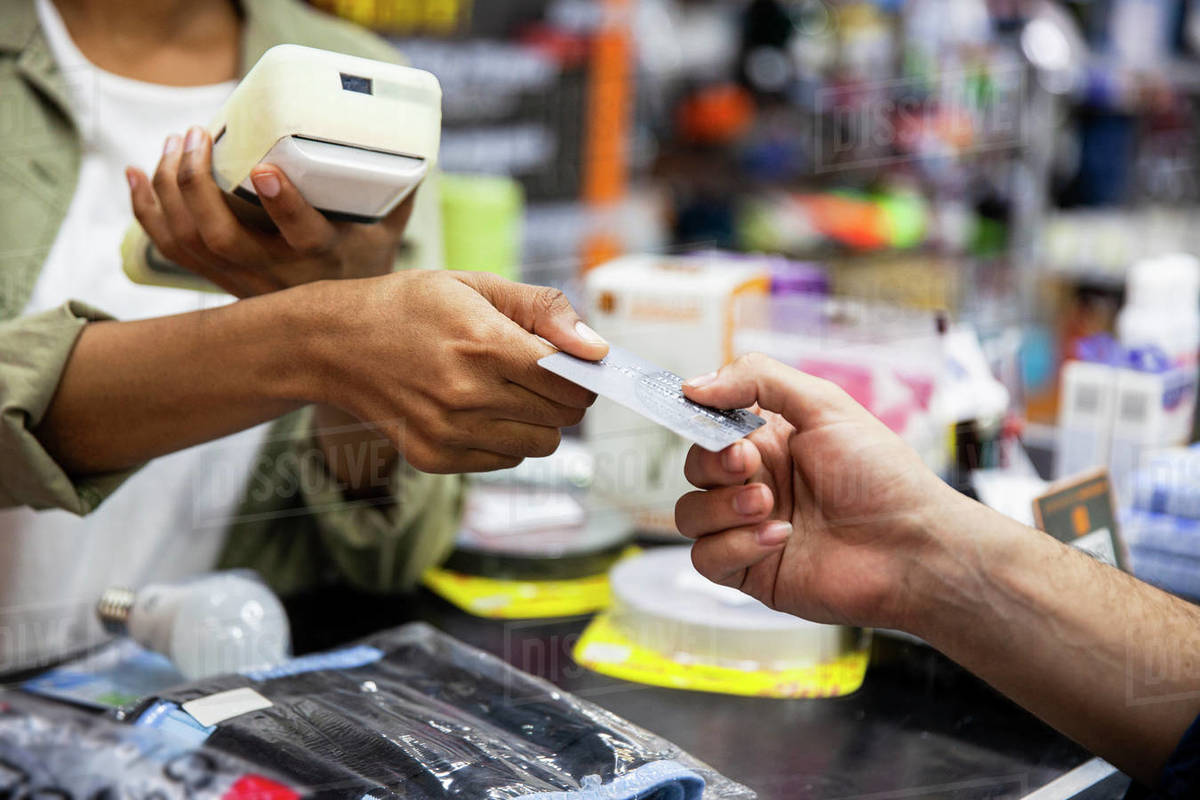 Customer paying through credit card in hardware shop - Stock Photo ...