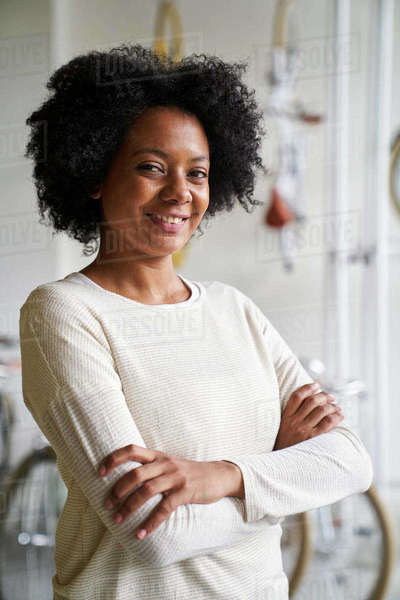 Medium shot of female African-American entrepreneur looking at camera ...
