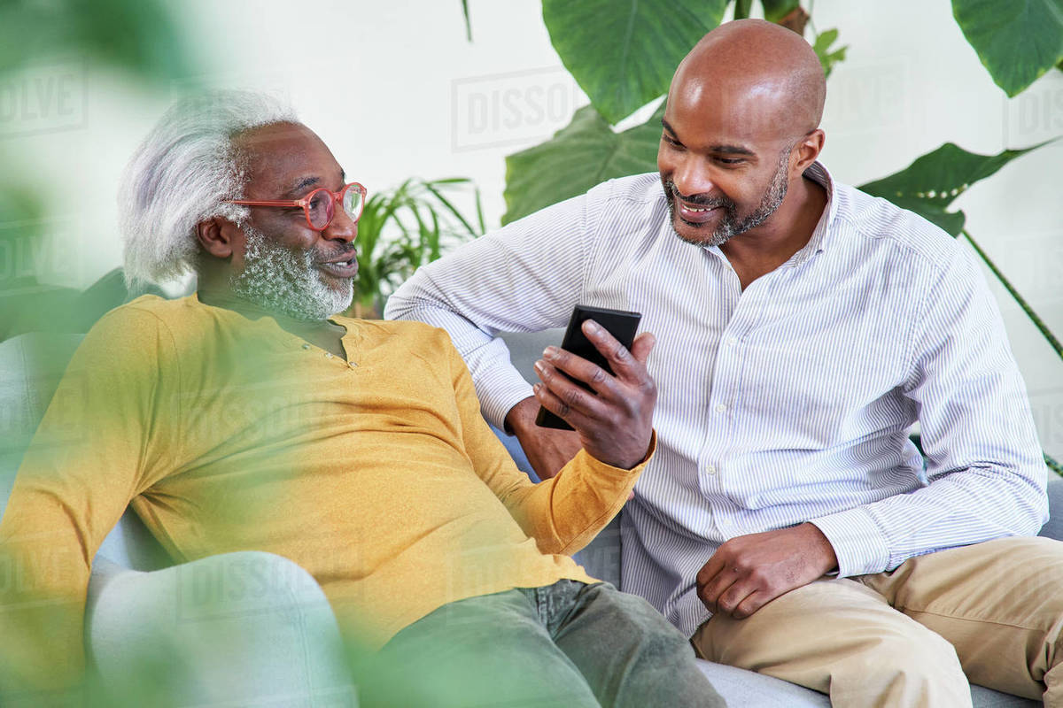 Father and son using smart phone - Royalty-free Stock Photo | Dissolve