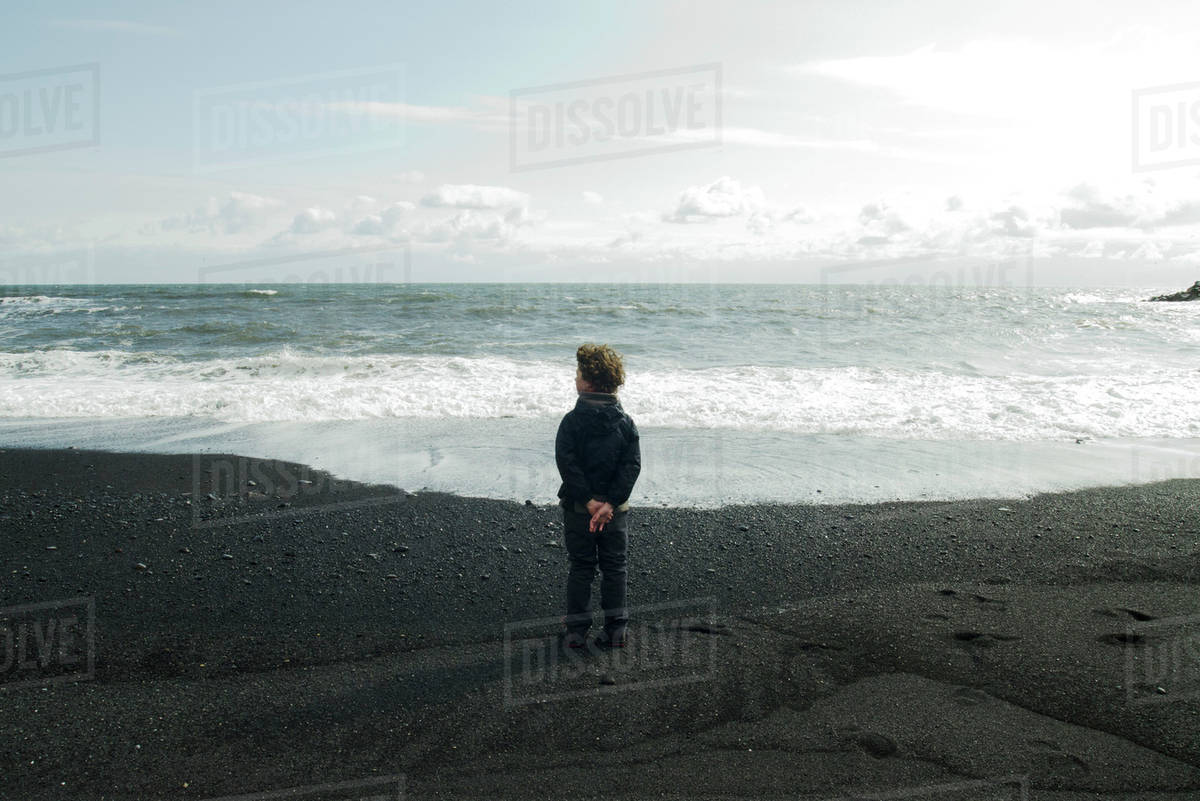 Boy looking horizon facing the sea, iceland - Royalty-free Stock Photo ...