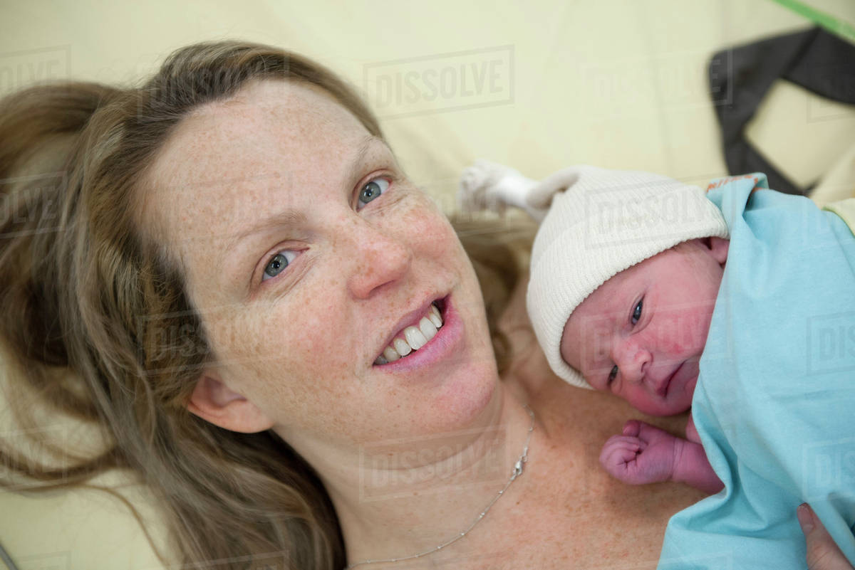 Mother holding newborn baby - Royalty-free Stock Photo | Dissolve