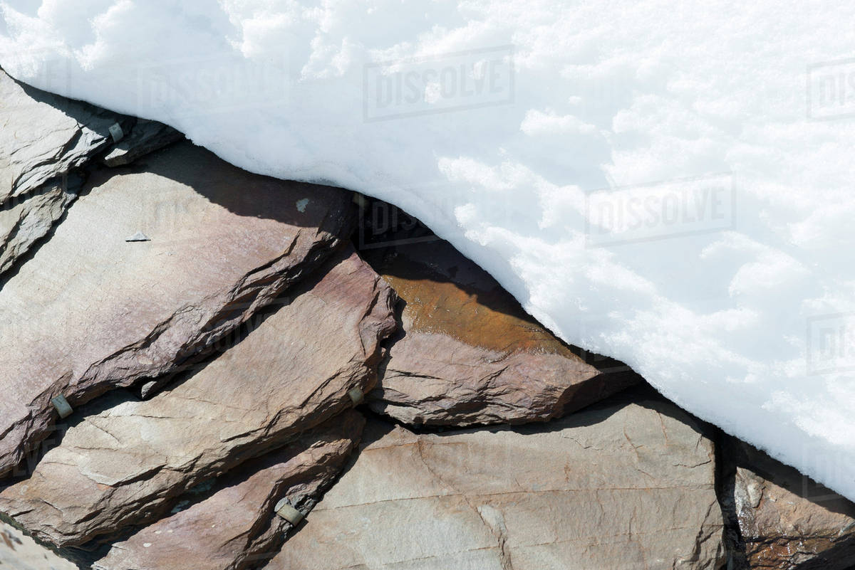 Snow on stones - Stock Photo - Dissolve