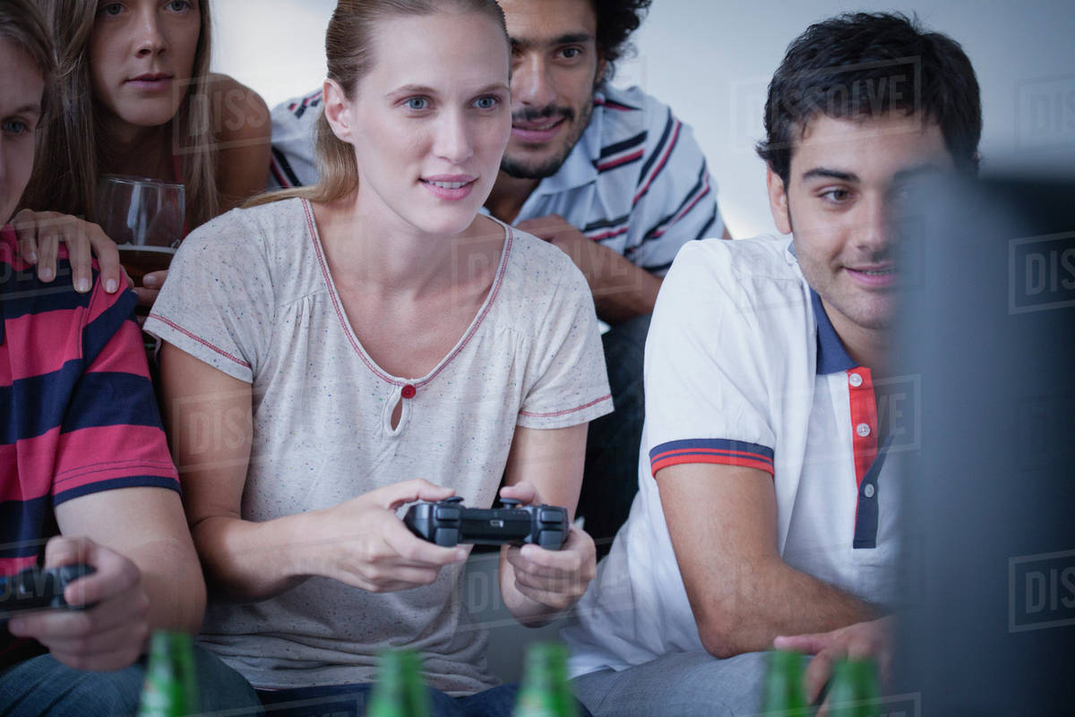 Friends playing video games together - Stock Photo - Dissolve