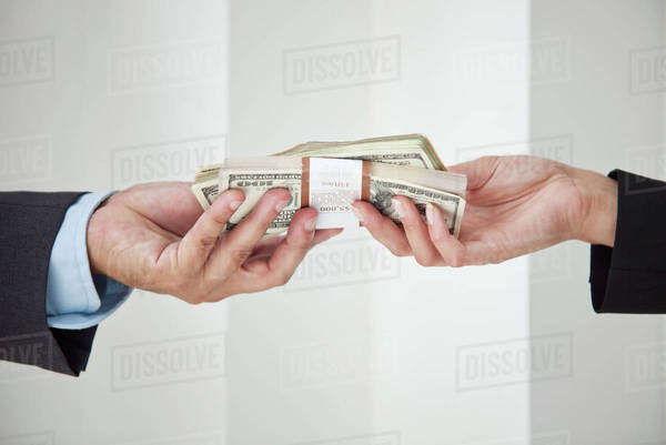 Businessman and businesswoman holding stacks of cash - Royalty-free ...