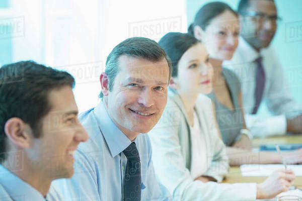 Businessman smiling in meeting - Royalty-free Stock Photo | Dissolve