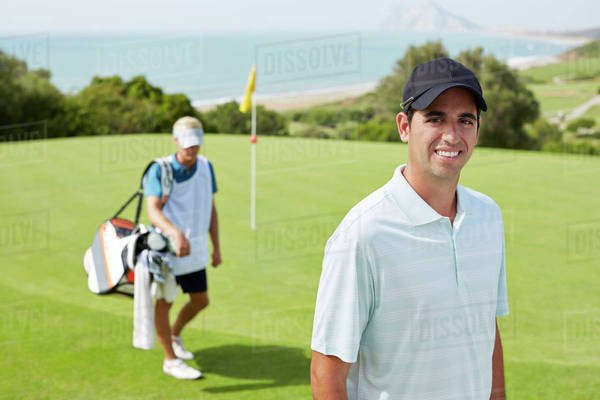 Caddy and golfer on golf course - Royalty-free Stock Photo | Dissolve