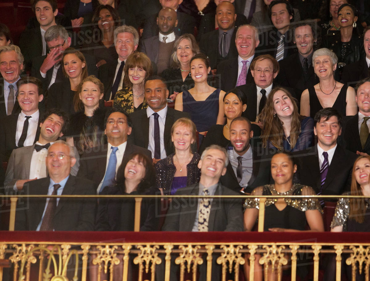 Laughing audience in theater balcony - Stock Photo - Dissolve