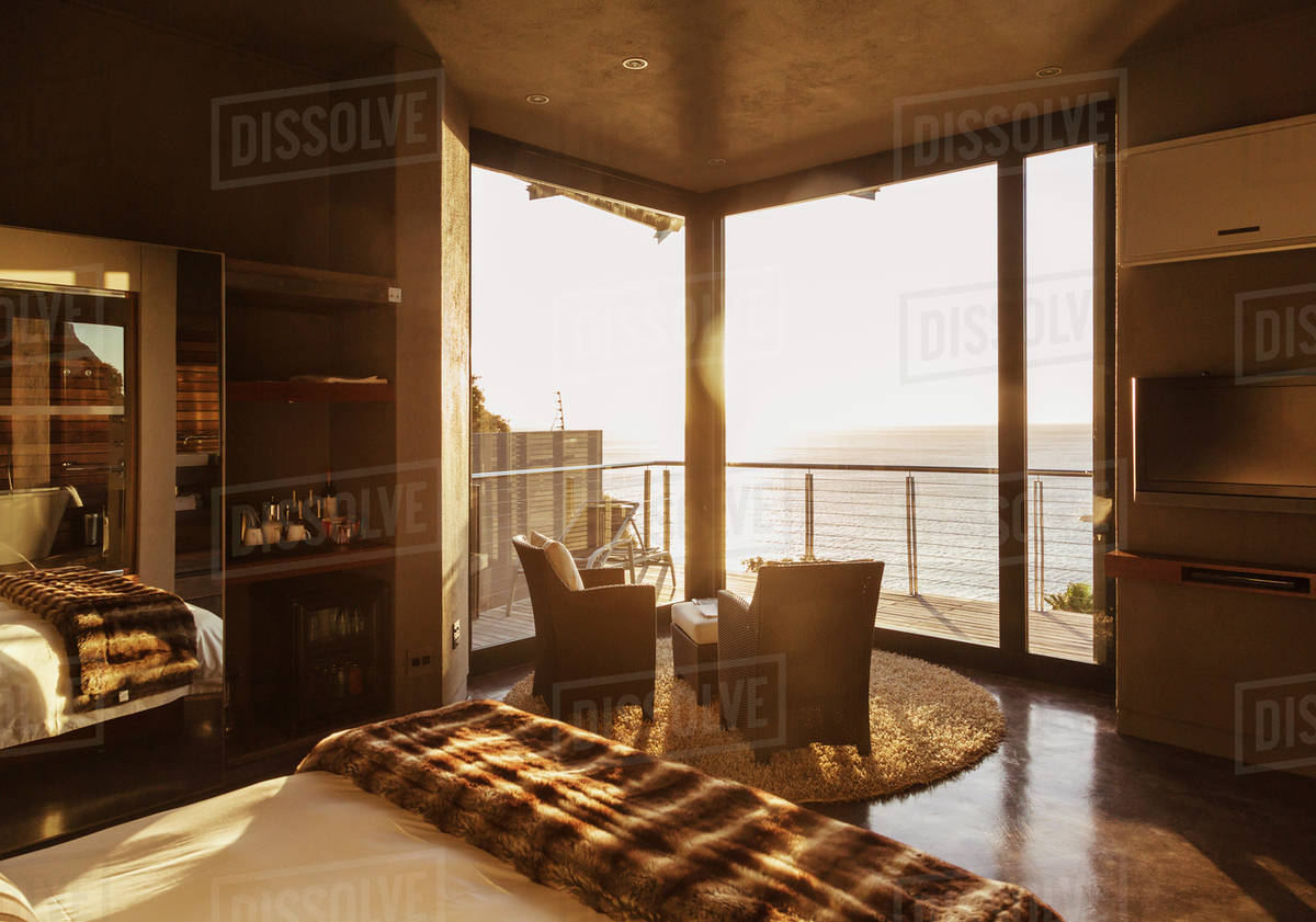 Luxury bedroom overlooking ocean at sunset - Royalty-free Stock Photo ...