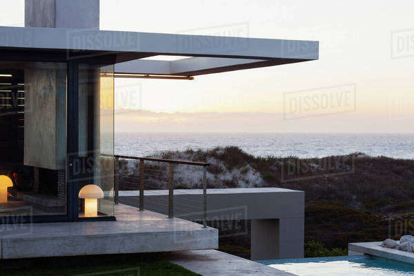 Modern house overlooking ocean at sunset - Royalty-free Stock Photo ...