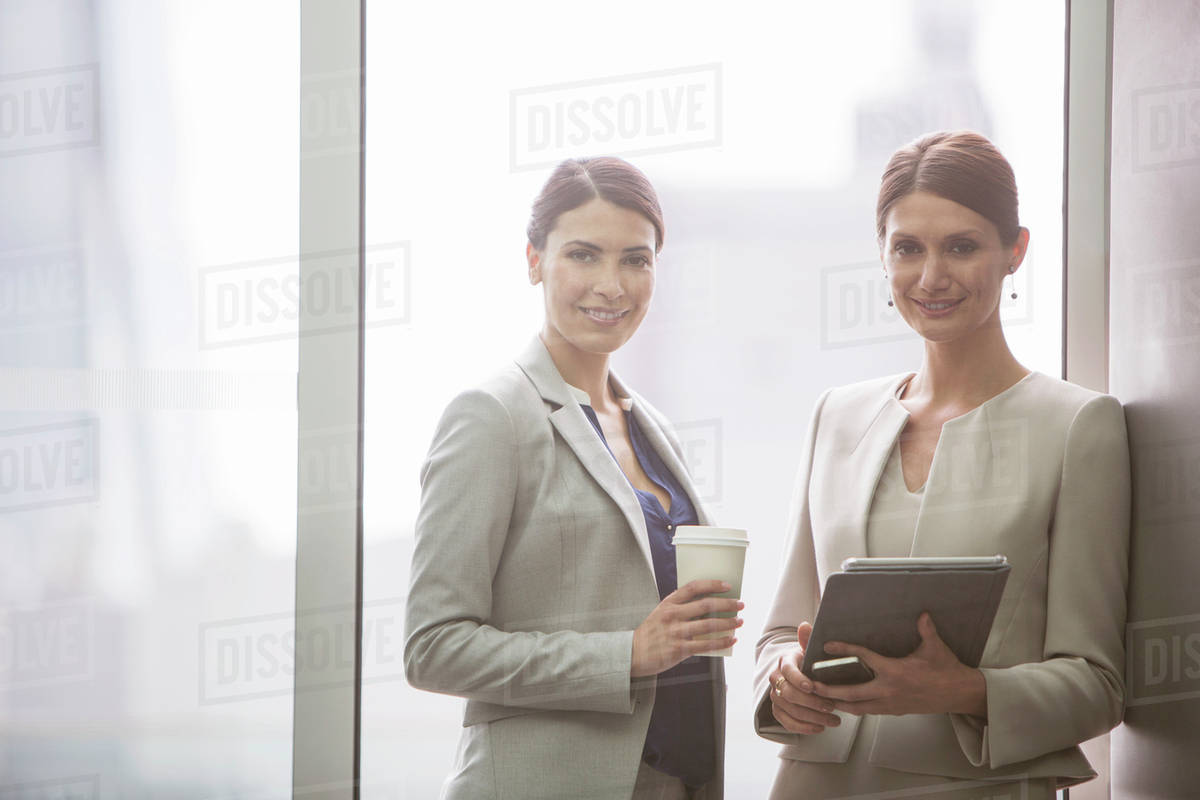 Businesswomen smiling in office - Royalty-free Stock Photo | Dissolve