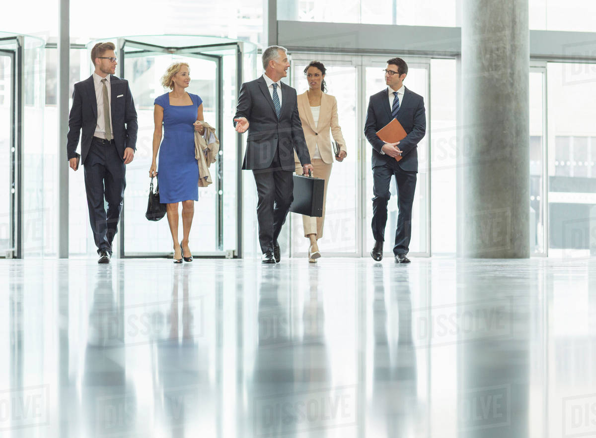 Business people walking in office - Royalty-free Stock Photo | Dissolve
