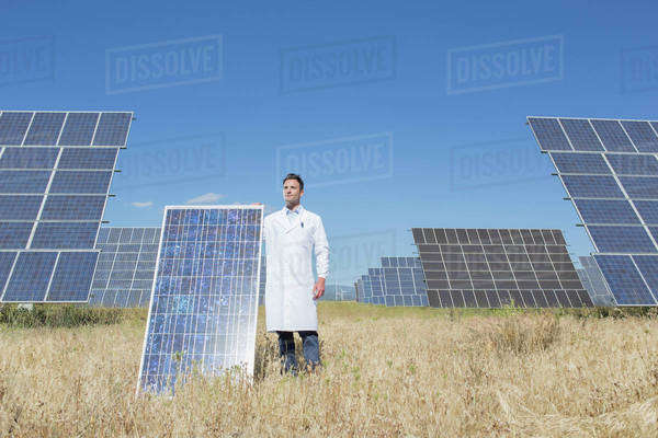 Scientist holding solar panel in rural landscape - Royalty-free Stock ...