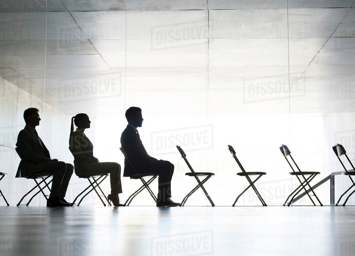 Business people sitting in office chairs in a row - Royalty-free Stock ...