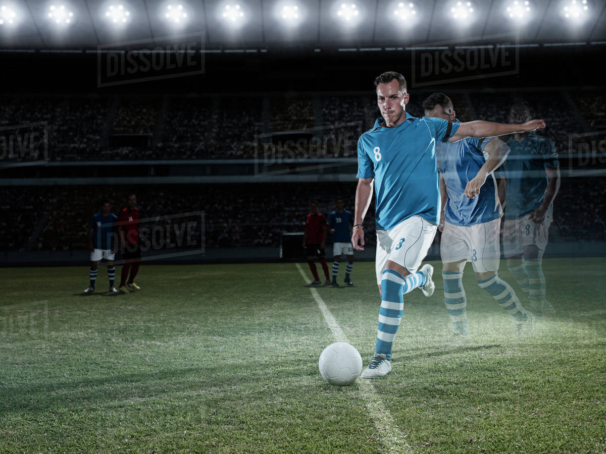 Soccer player approaching ball on field - Stock Photo - Dissolve