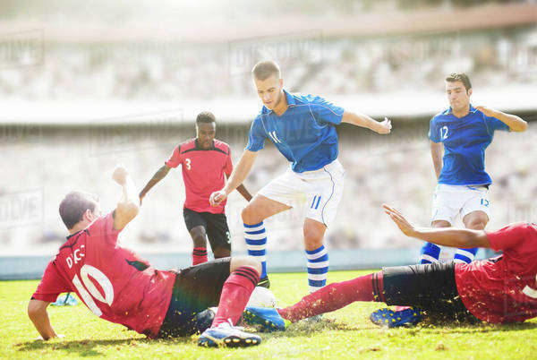 Soccer players sliding on field - Royalty-free Stock Photo | Dissolve