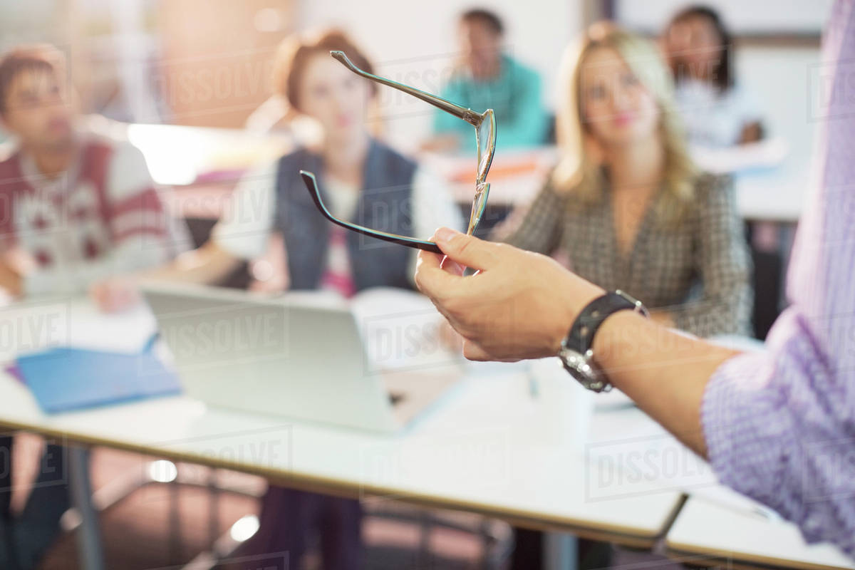 Professor gesturing with eyeglasses in classroom - Royalty-free Stock ...