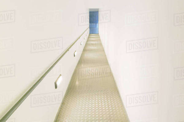 Person standing at top of steep ramp - Stock Photo - Dissolve