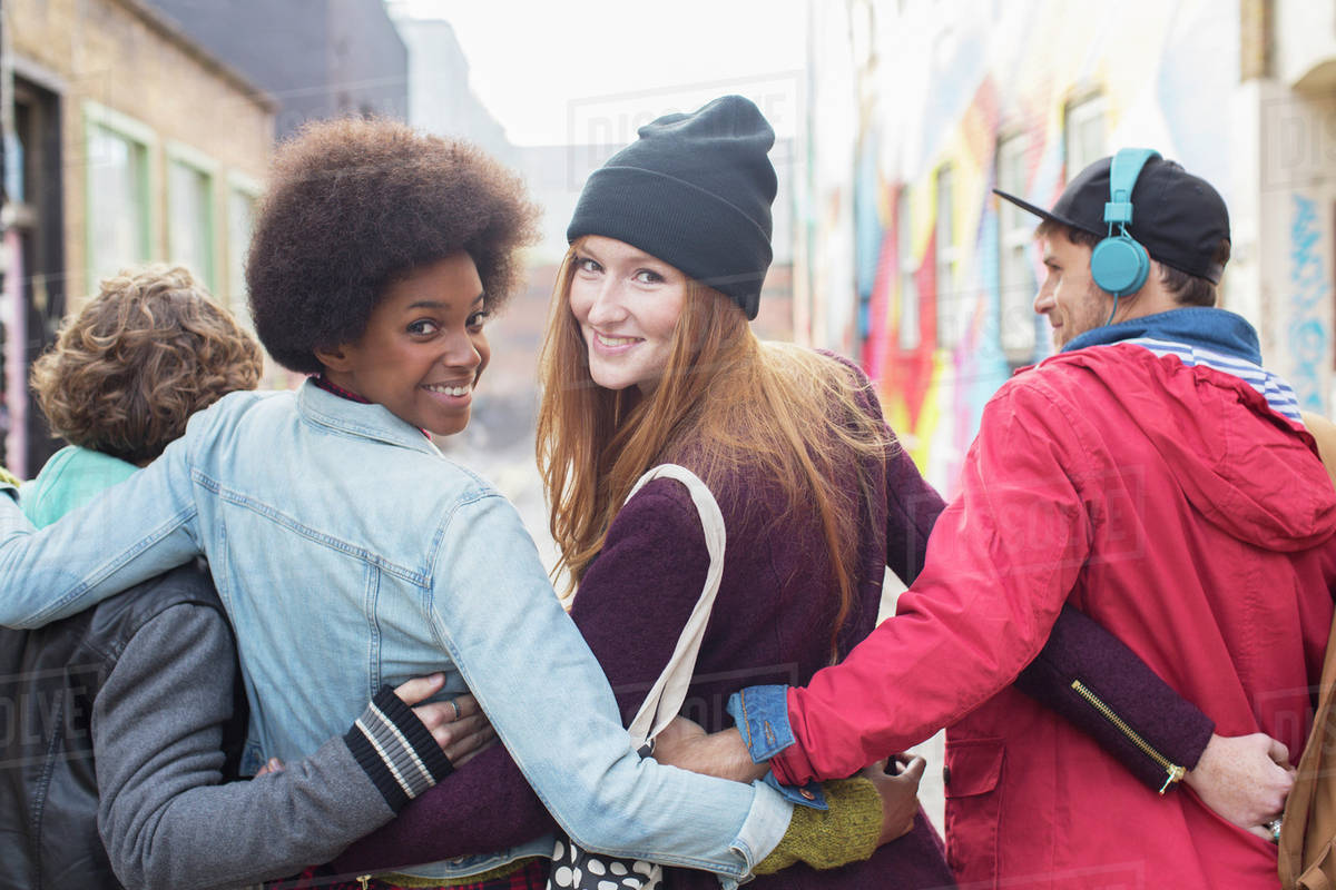 Friends walking together on city street - Royalty-free Stock Photo ...