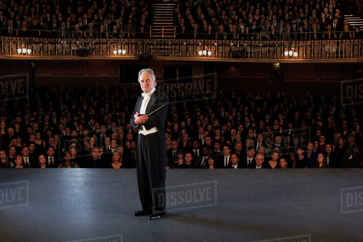 Conductor posing on stage in theater - Royalty-free Stock Photo | Dissolve