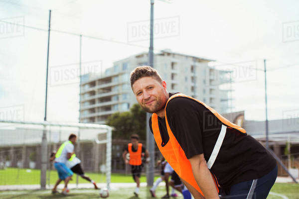 Soccer player smiling on field - Royalty-free Stock Photo | Dissolve