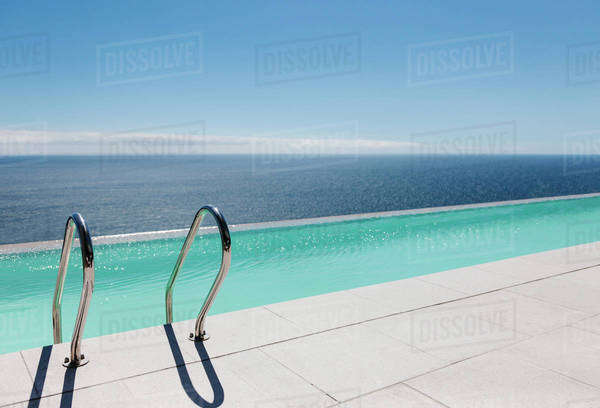 Infinity pool overlooking ocean - Stock Photo - Dissolve