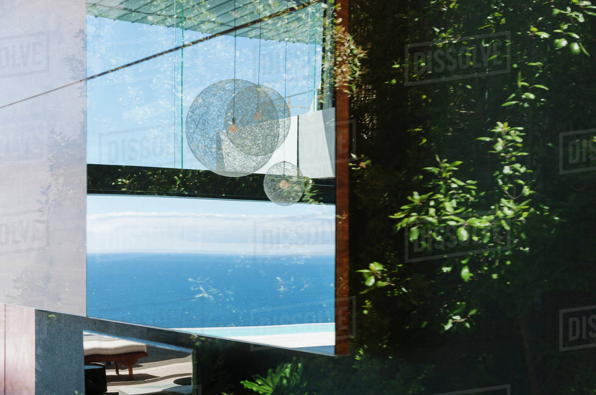 Reflection on window overlooking ocean - Stock Photo - Dissolve