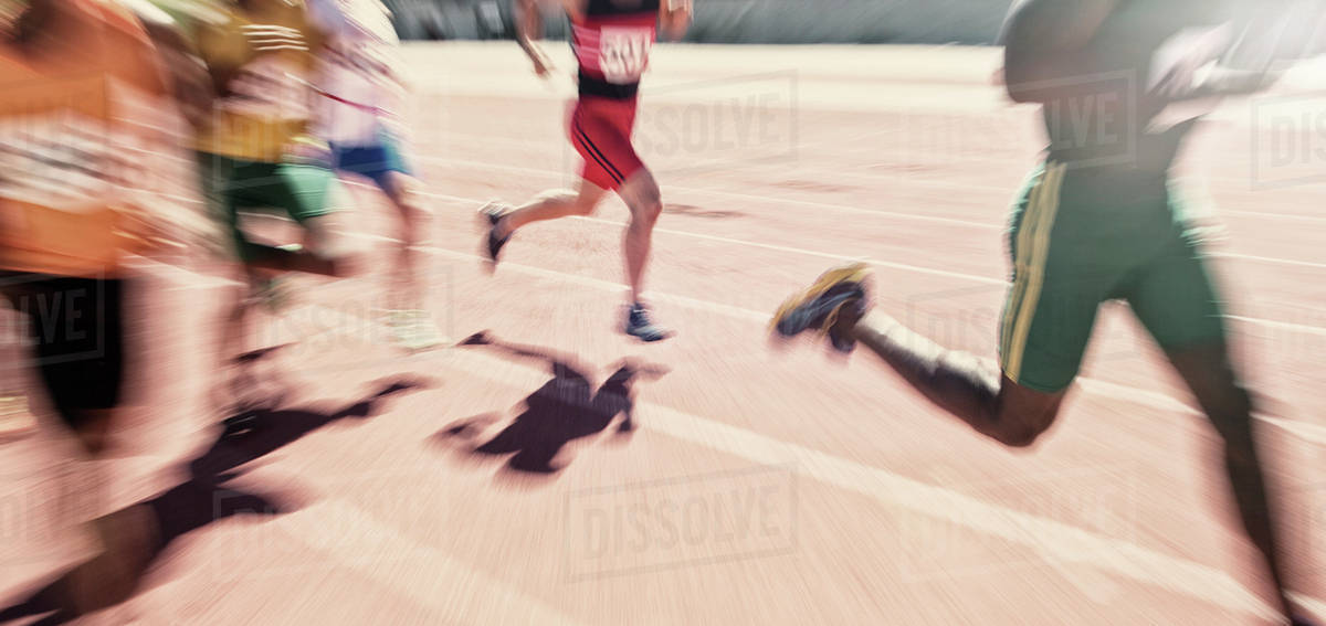 Runners racing on track - Stock Photo - Dissolve