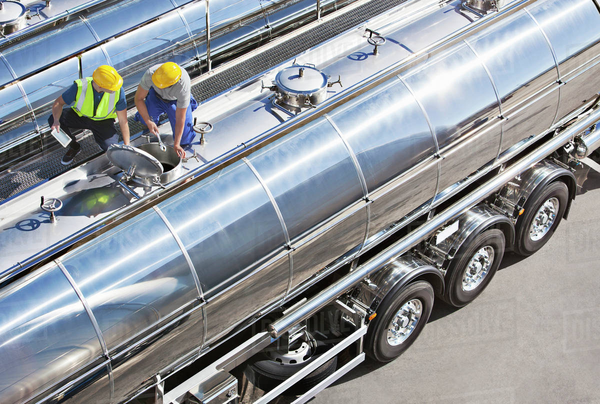 Workers on top of stainless steel milk tanker - Royalty-free Stock ...