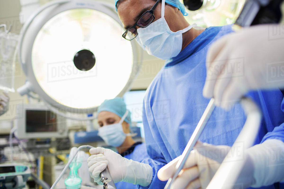 Doctor performing surgery in operating theater - Royalty-free Stock ...